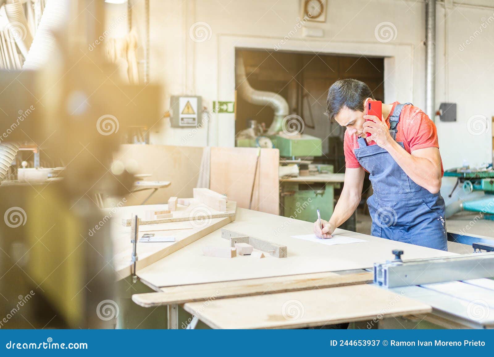 Carpenter Talking on Phone while Taking Notes Stock Image - Image of ...
