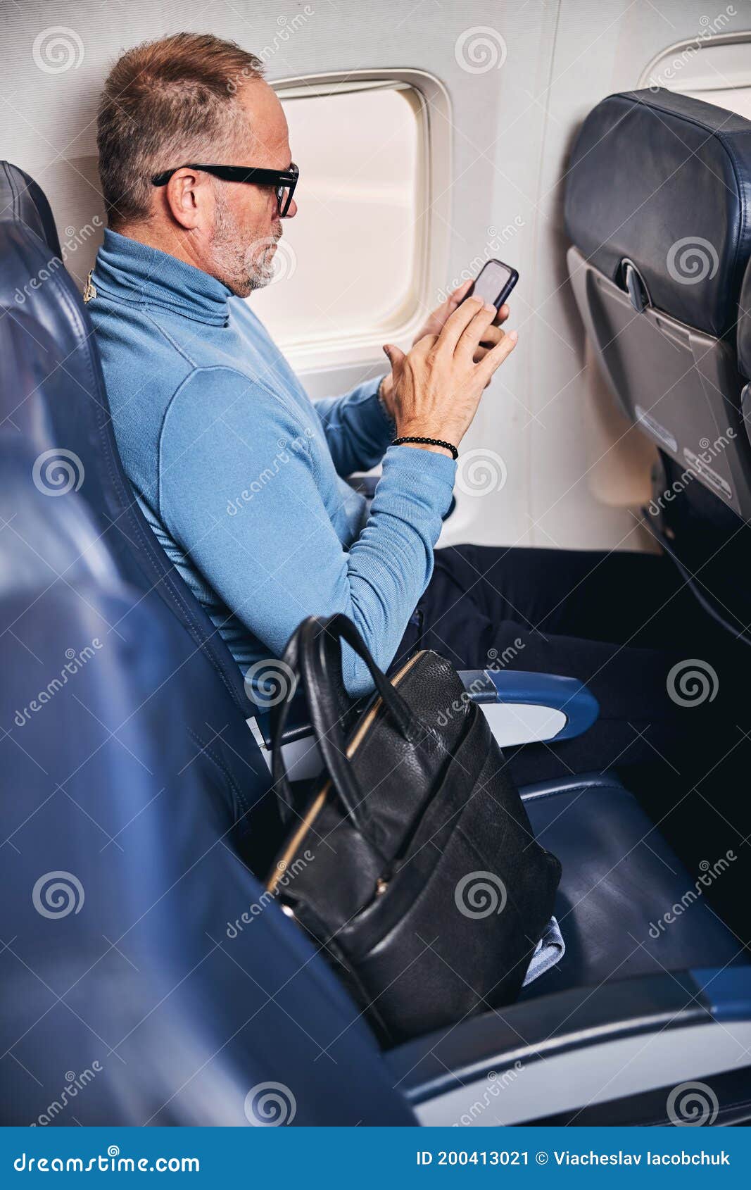 Airplane Passenger in a Jumper Texting on the Cellphone Stock Image ...