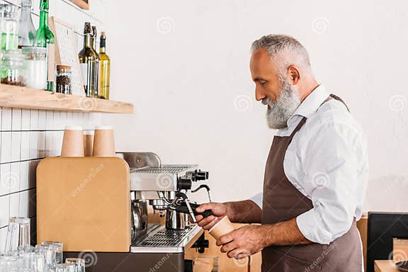 Side View of Focused Senior Barista Using Coffee Machine while Stock ...