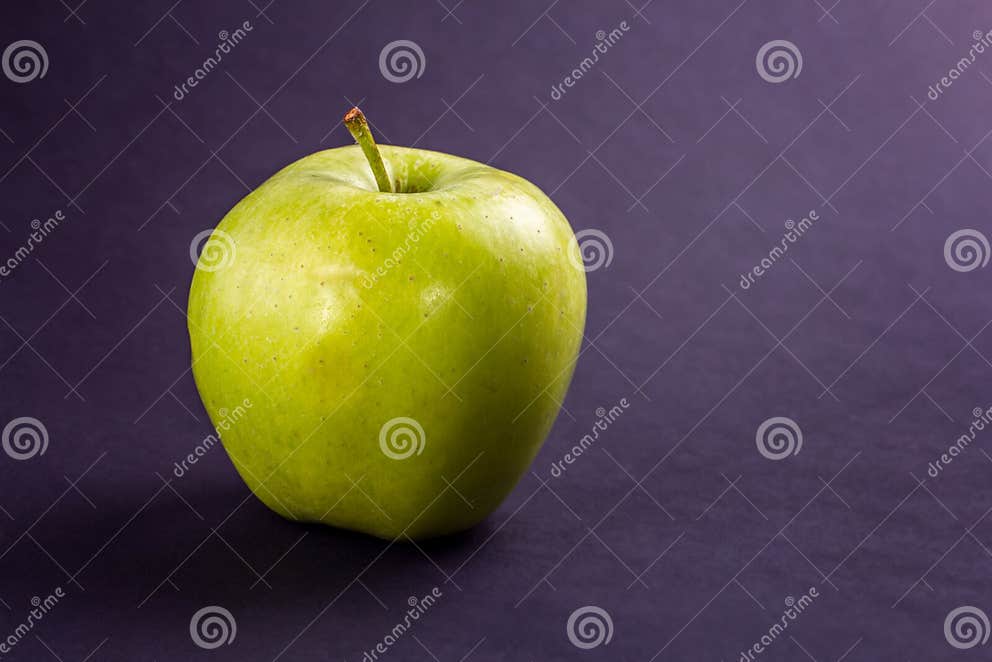 Side View of a Fresh Green Apple on a Black Textured Surface. Copy ...