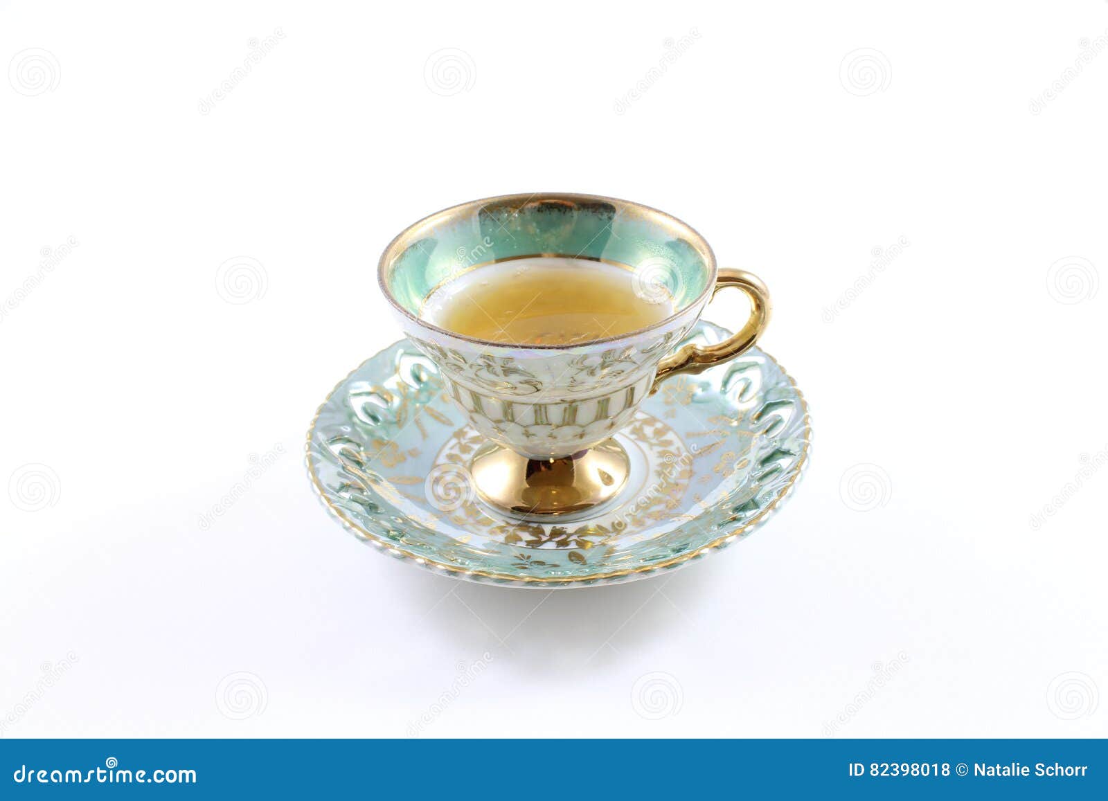 Side View of Green and White Teacup and Saucer with Tea Stock Photo ...