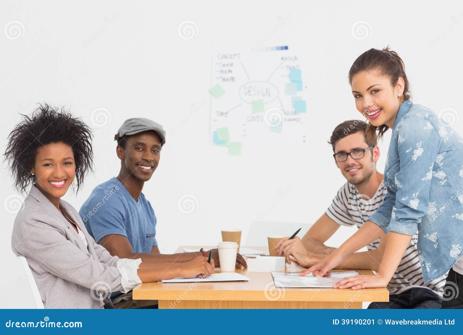 Side View of a Group of Artists in Discussion at Desk Stock Image ...