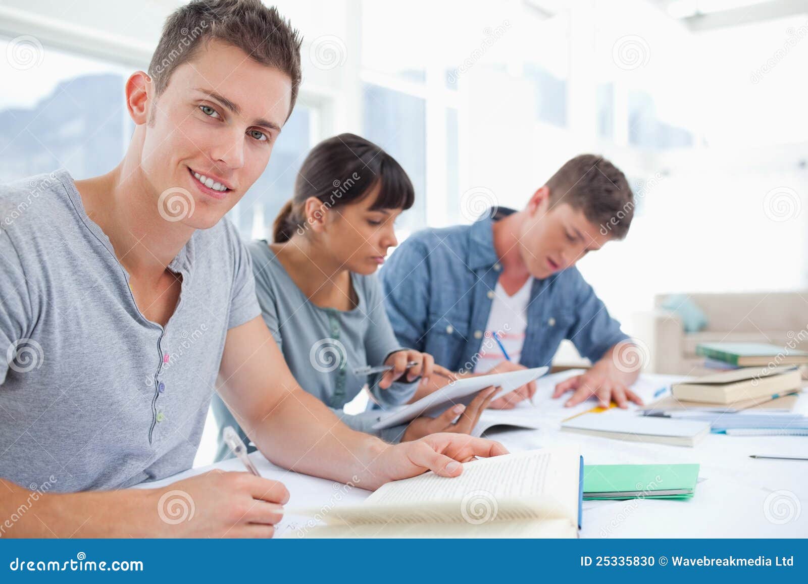 Side View of a Group of Students As One Student Looks at the Cam Stock ...