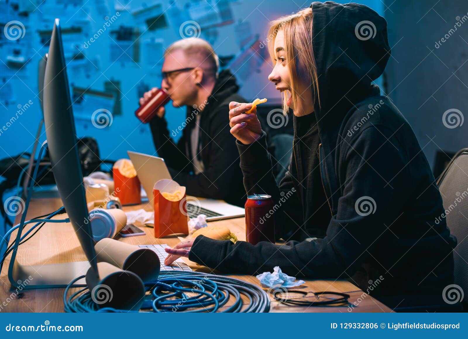 Side View of Hackers Eating Junk Food while Working Stock Photo - Image ...