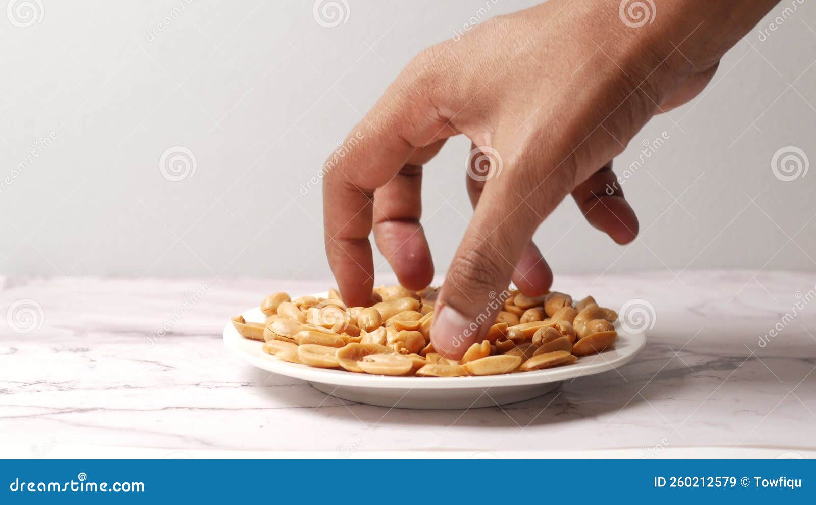Side View of Hand Pick Peanuts from a Plate Stock Video - Video of ...
