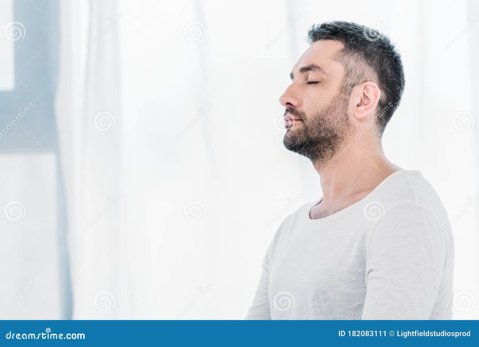 Side View of Handsome Bearded Man with Eyes Closed at Home with ...