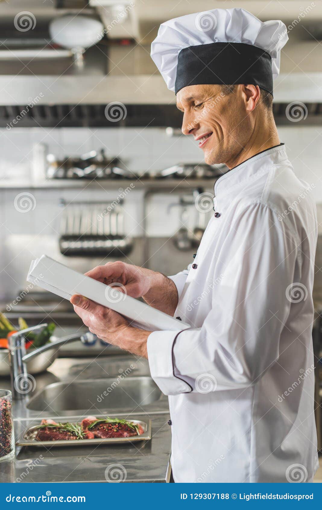 Side View of Handsome Chef Reading Recipe Book Stock Photo - Image of ...