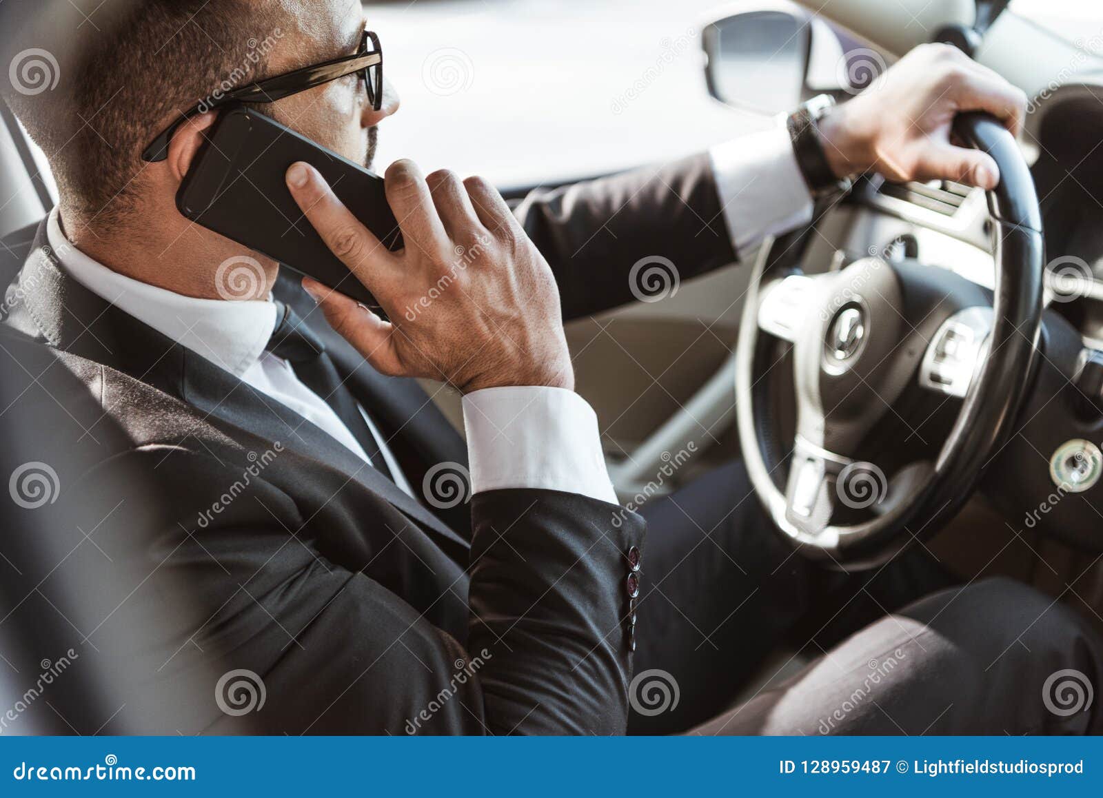 Side View of Handsome Driver in Suit Driving Car and Talking Stock ...