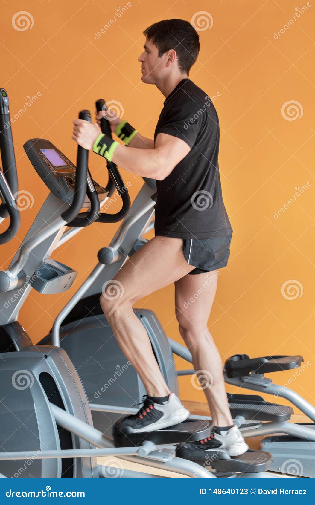 Side View of Handsome Man on Elliptical Trainer. Stock Image - Image of ...
