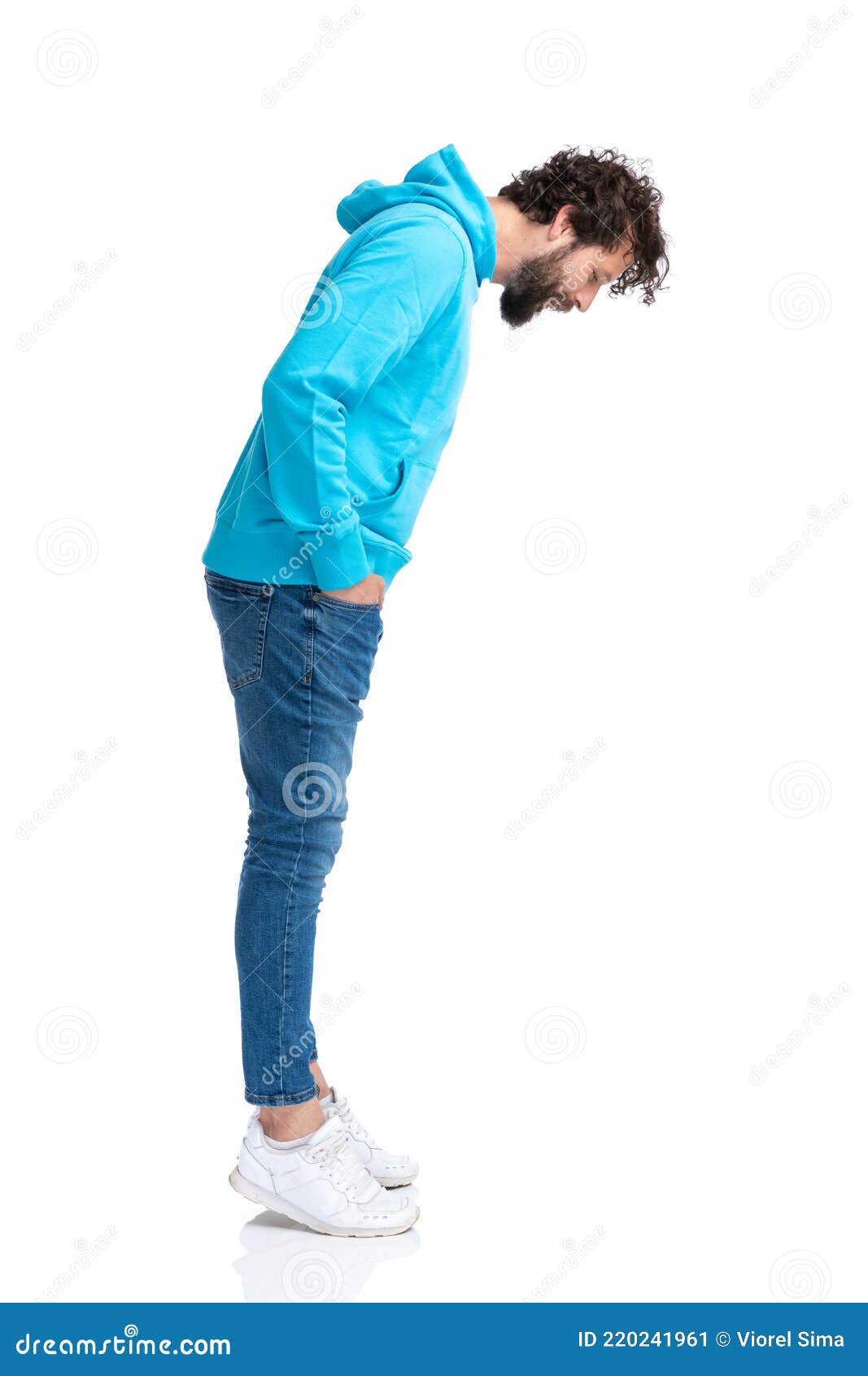 Side View of Handsome Man Holding Hands in Pockets and Looking Down ...