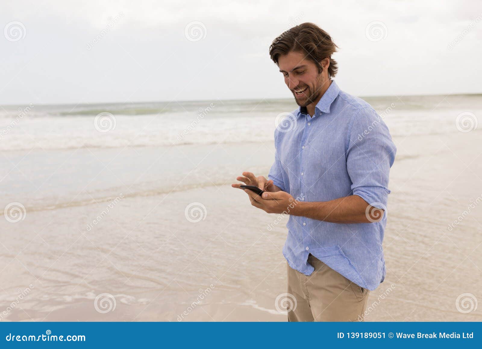 Man Using Mobile Phone on the Beach Stock Image - Image of holiday ...