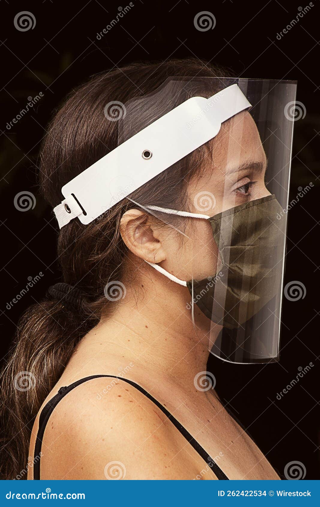 Side View of a Hispanic Female Wearing a Facemask and a Face Shield ...