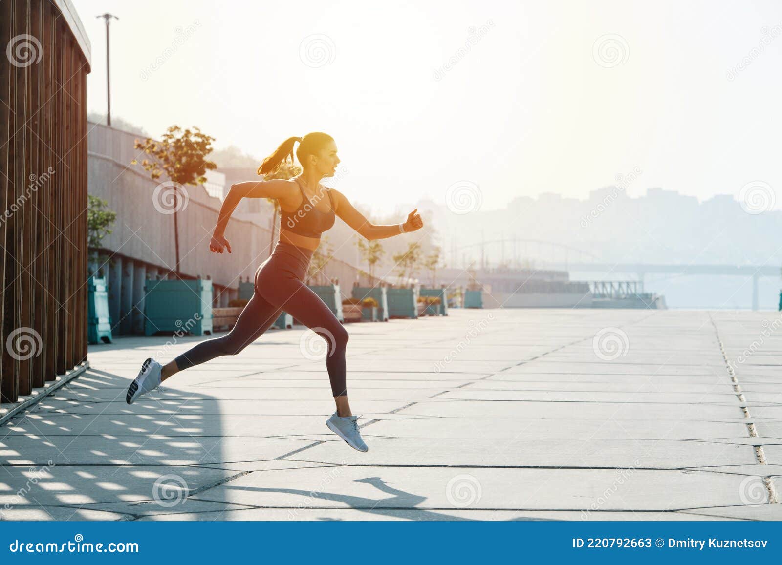 Side View Image of a Brunette Running on the Pavement Outdoors. Low ...