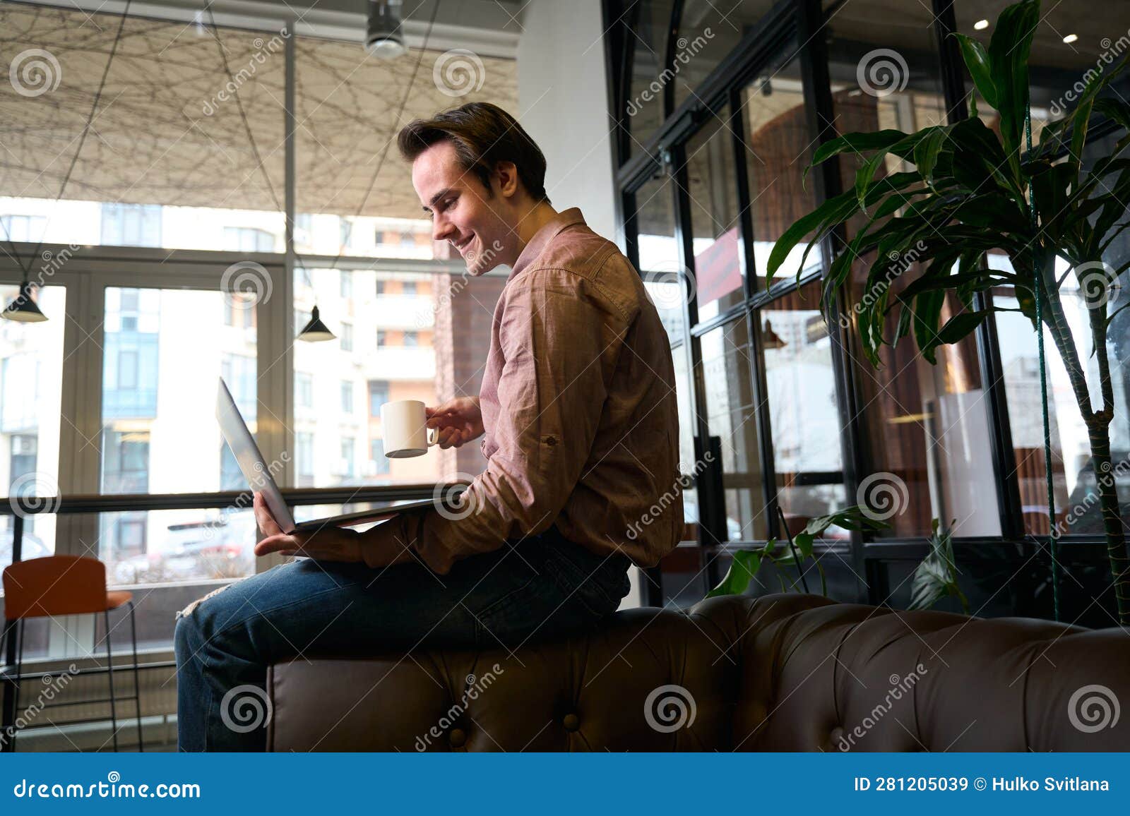 Smiling Man Reading Something on Portable Computer in Coworking Space ...
