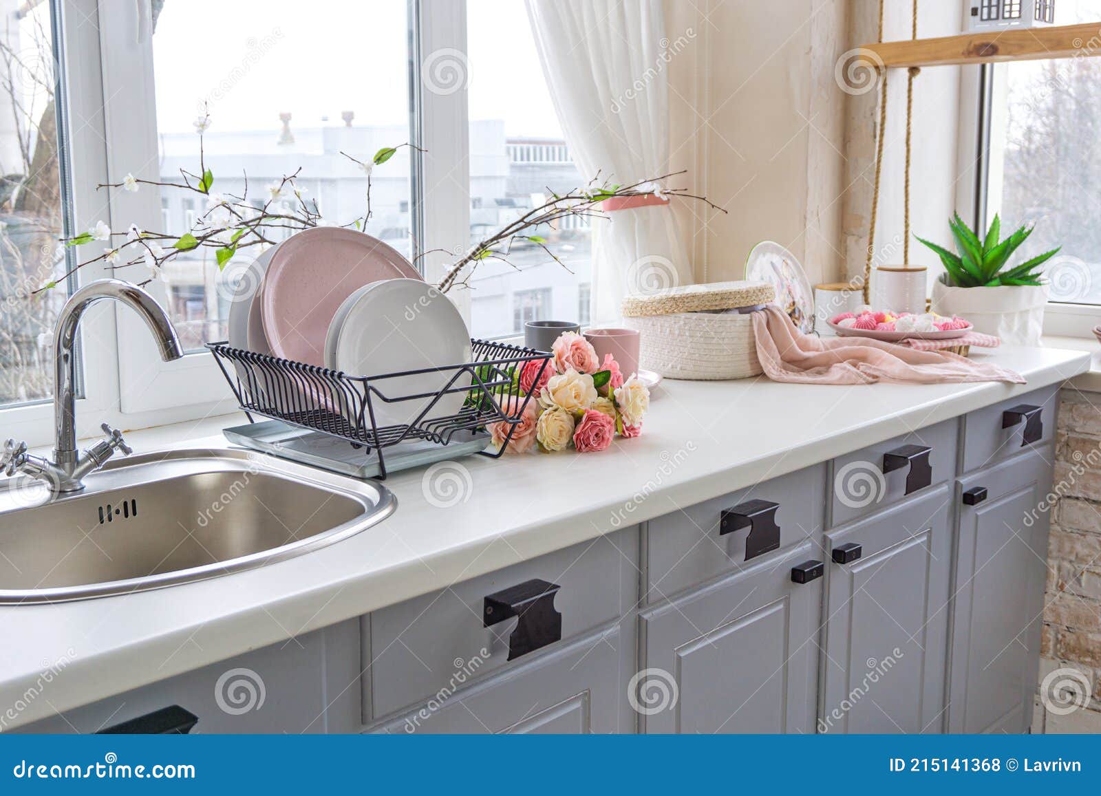 Side View of Kitchen Sink , Flowers and Plates Near the Window Stock ...
