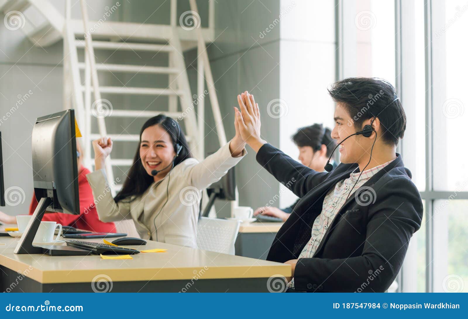 Side View of Line of Call Center Employees are Smiling and Working on ...