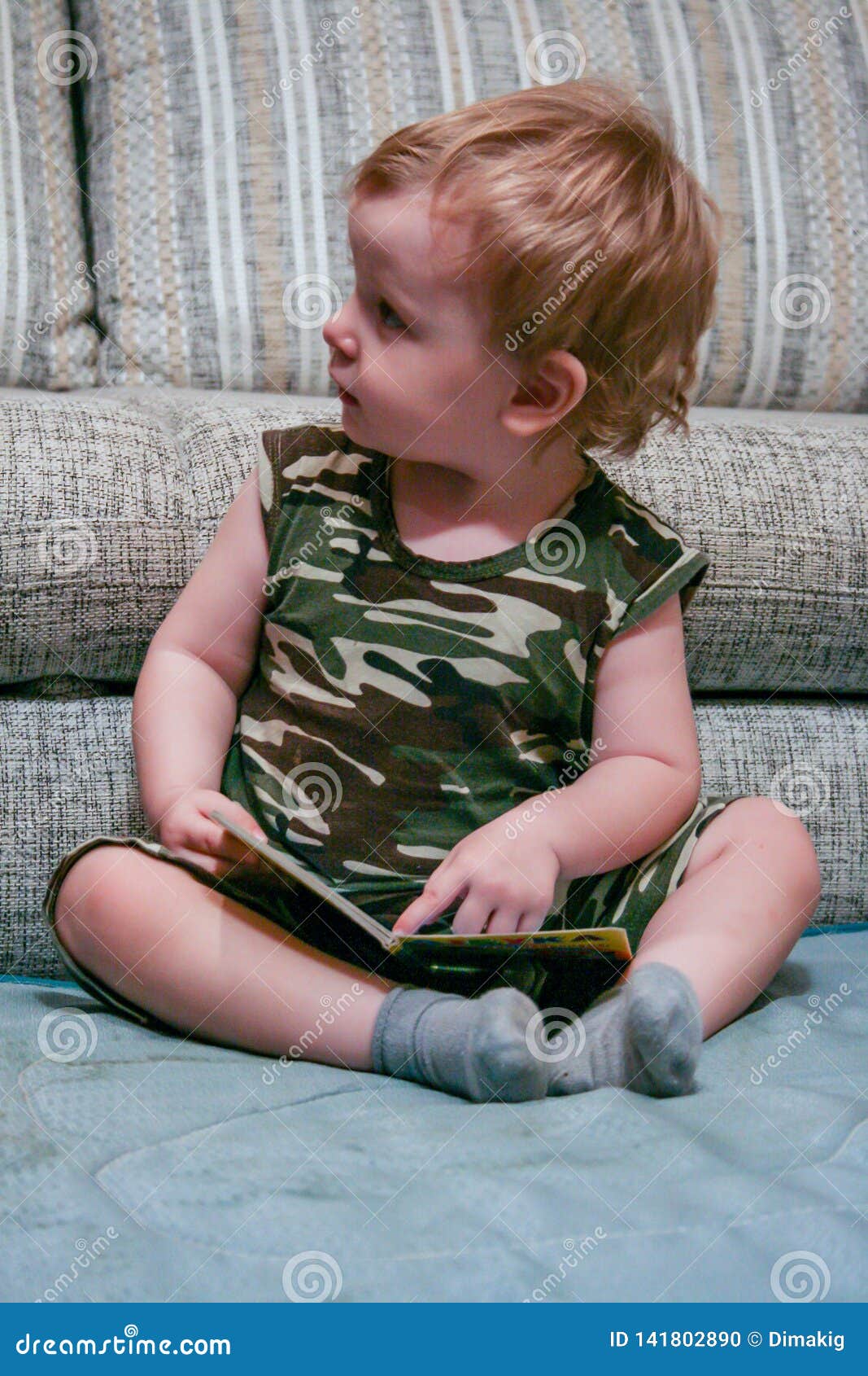 Side View of a Little Boy Sitting on the Floor. Stock Photo - Image of ...