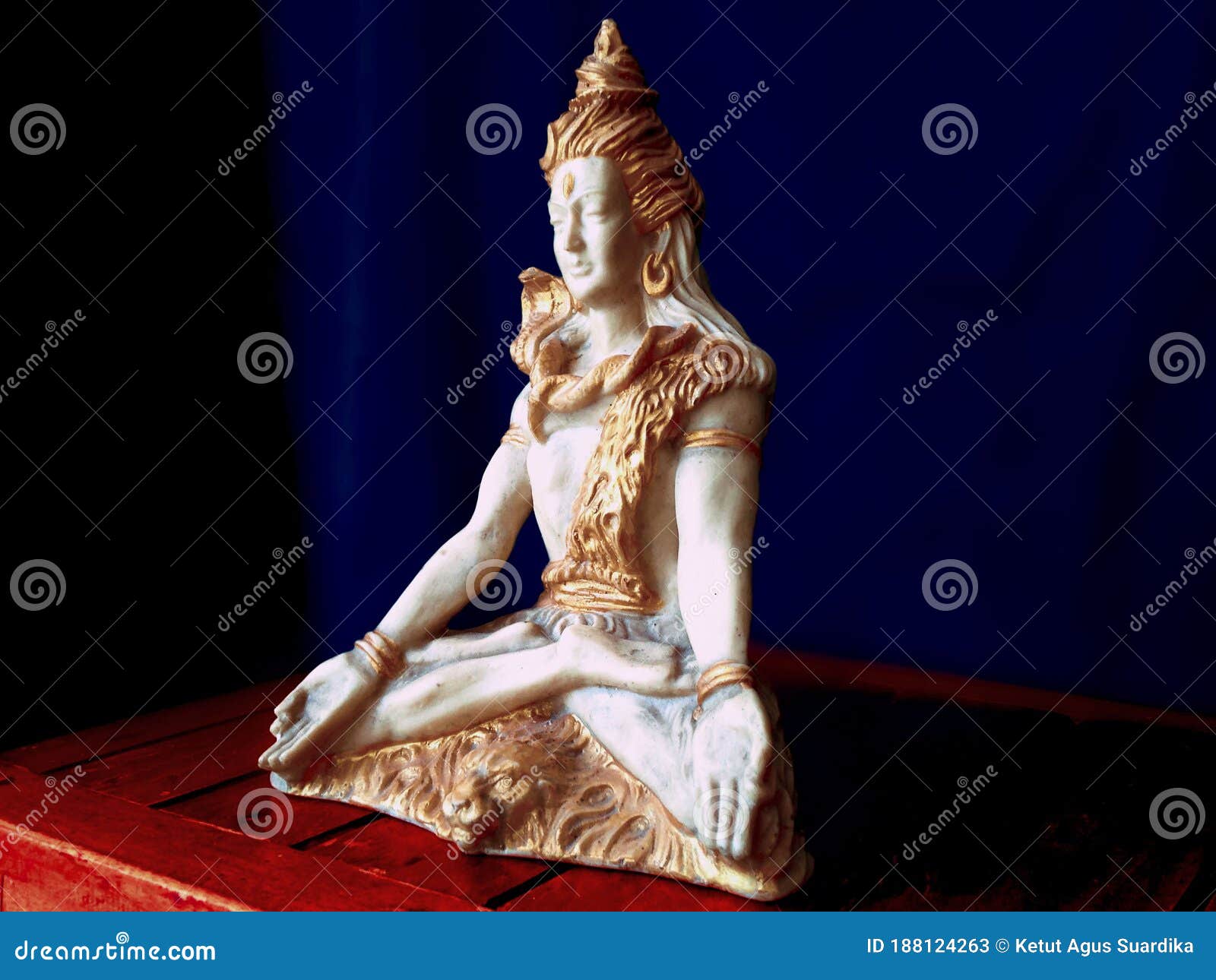 Side View Lord Shiva Mini Statue On Table With Blue Background Royalty ...