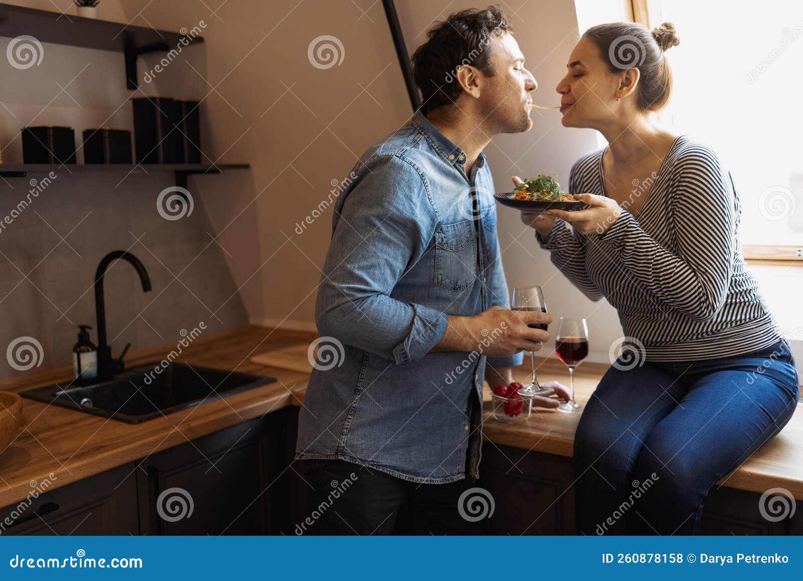 Side View of Loving Couple Eating Same Spaghetti while Having Romantic ...