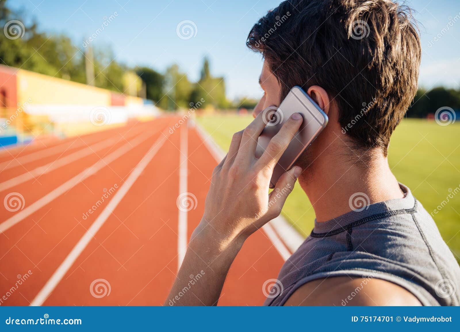 Side View of a Male Athlete Talking on Mobile Phone Stock Image - Image ...