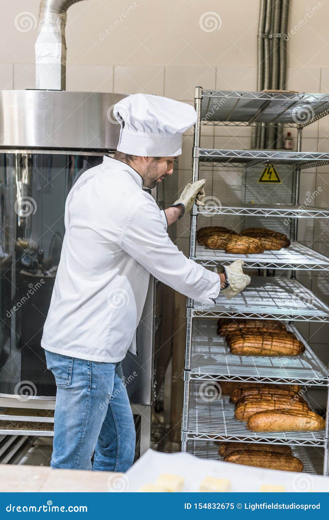 Side View of Male Chef Holding Rack with Loaves Stock Image - Image of ...