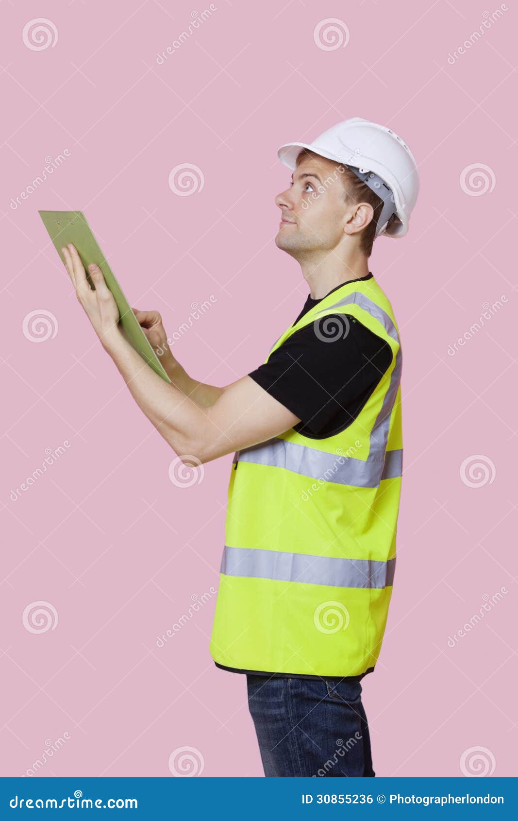 Side View of a Male Construction Worker with Clipboard Looking Away ...