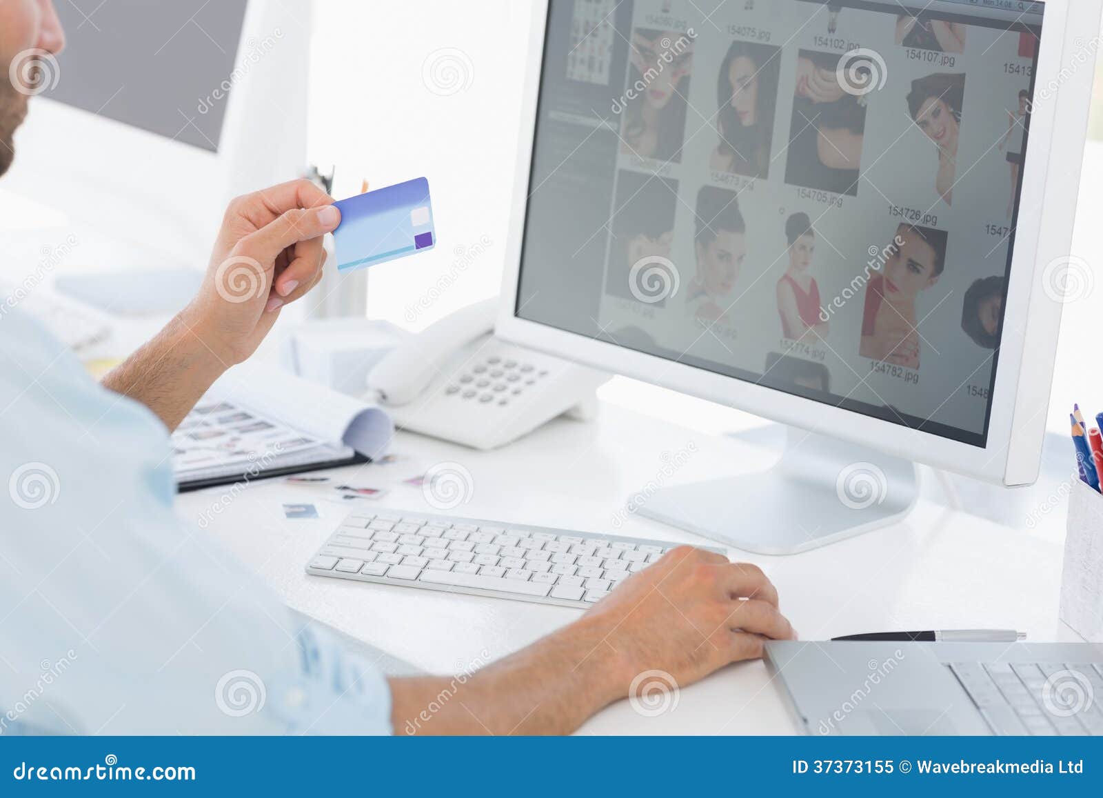 Side View of a Male Photo Editor Working on Computer Stock Image ...