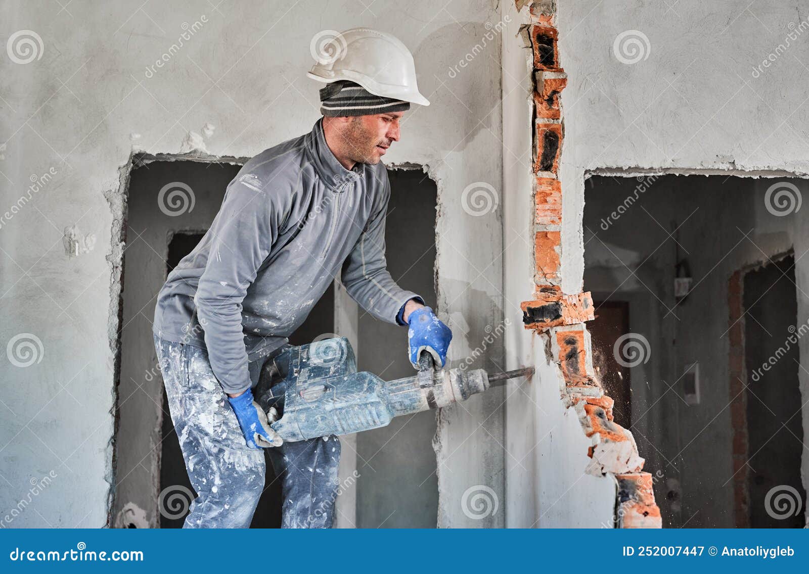 Builder Destroying Inner Partition by Jackhammer in Apartment. Stock ...