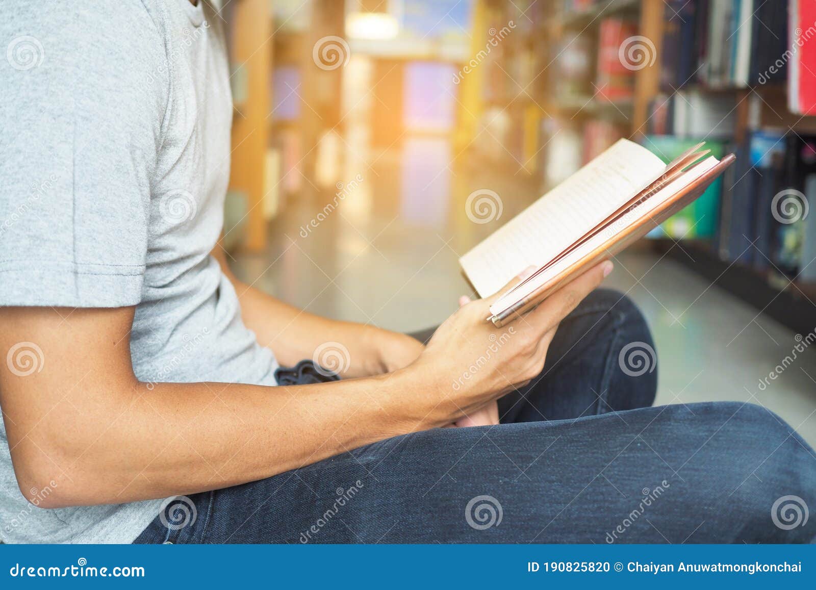 Side View of Male Student Reading Books in Library Stock Photo - Image ...