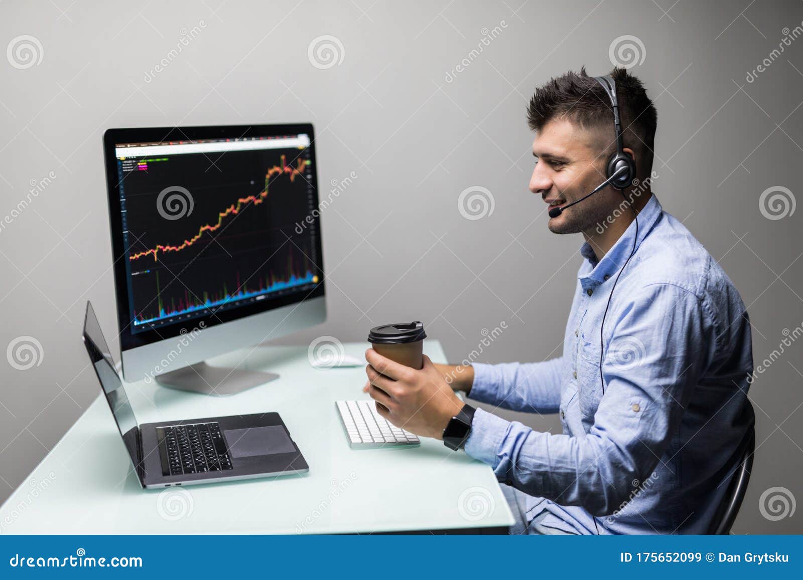 Side View of Male Trader with Coffee Cup Using Multiple Computer ...