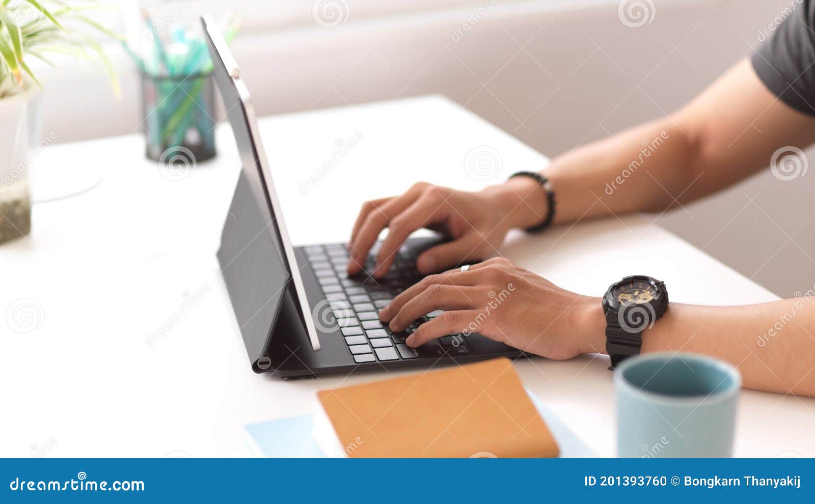 Side View of Male Typing on Tablet Keyboard on Worktable Stock Photo ...