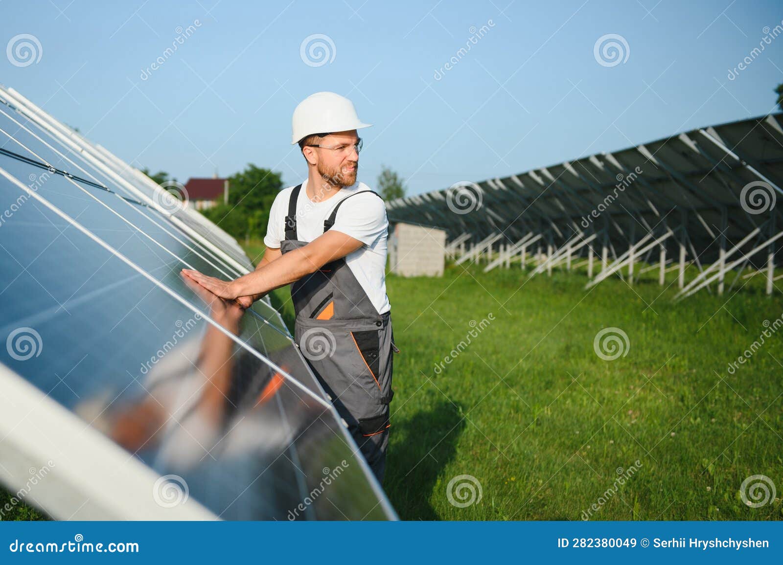 Side View of Male Worker Installing Solar Modules and Support ...