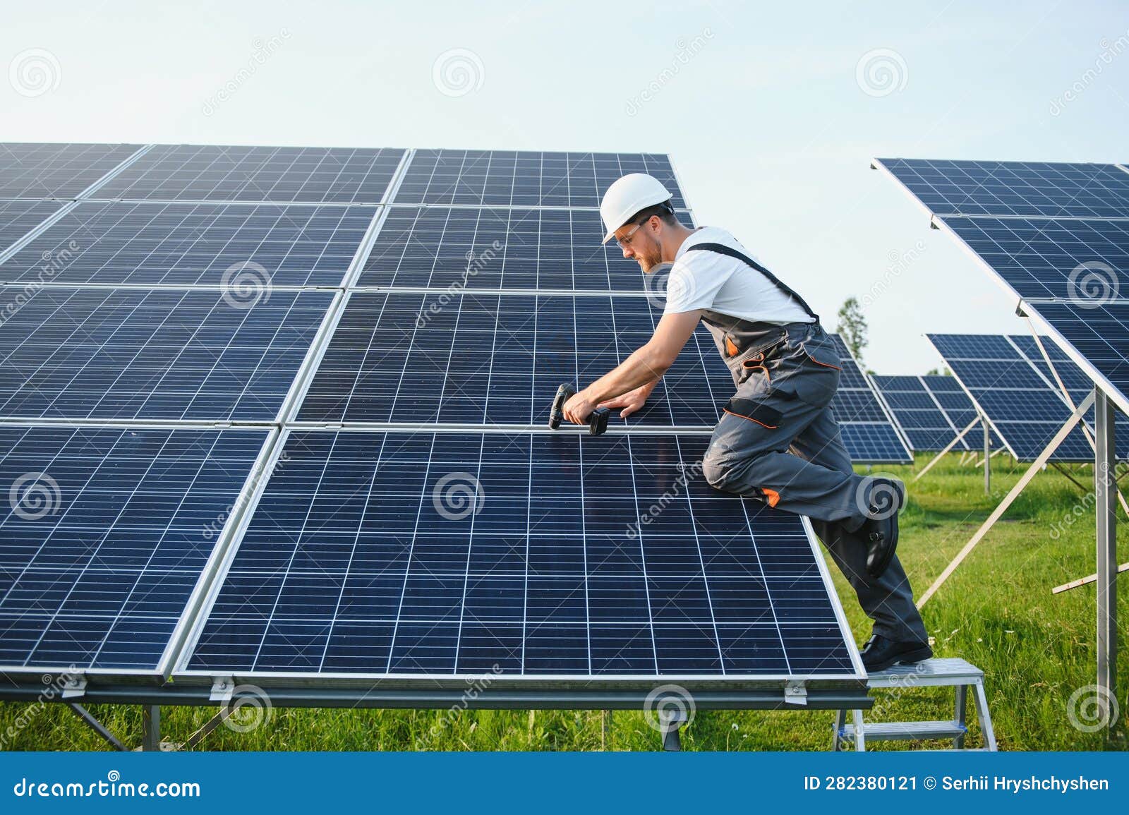 Side View of Male Worker Installing Solar Modules and Support ...