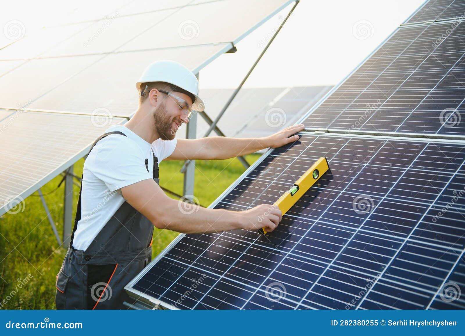 Side View of Male Worker Installing Solar Modules and Support ...