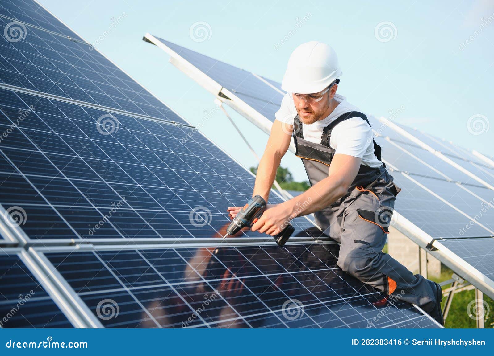 Side View of Male Worker Installing Solar Modules and Support ...