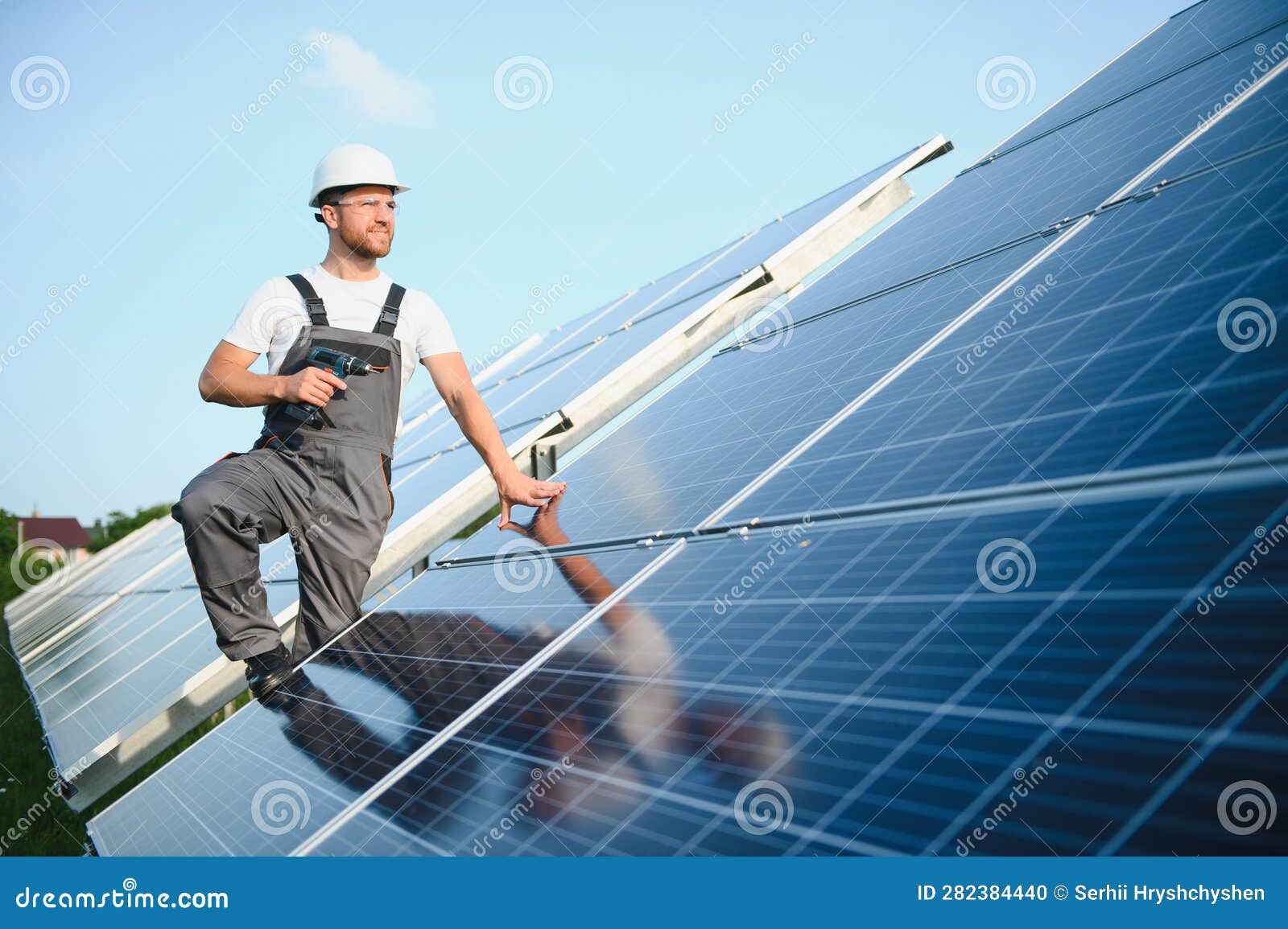 Side View of Male Worker Installing Solar Modules and Support ...