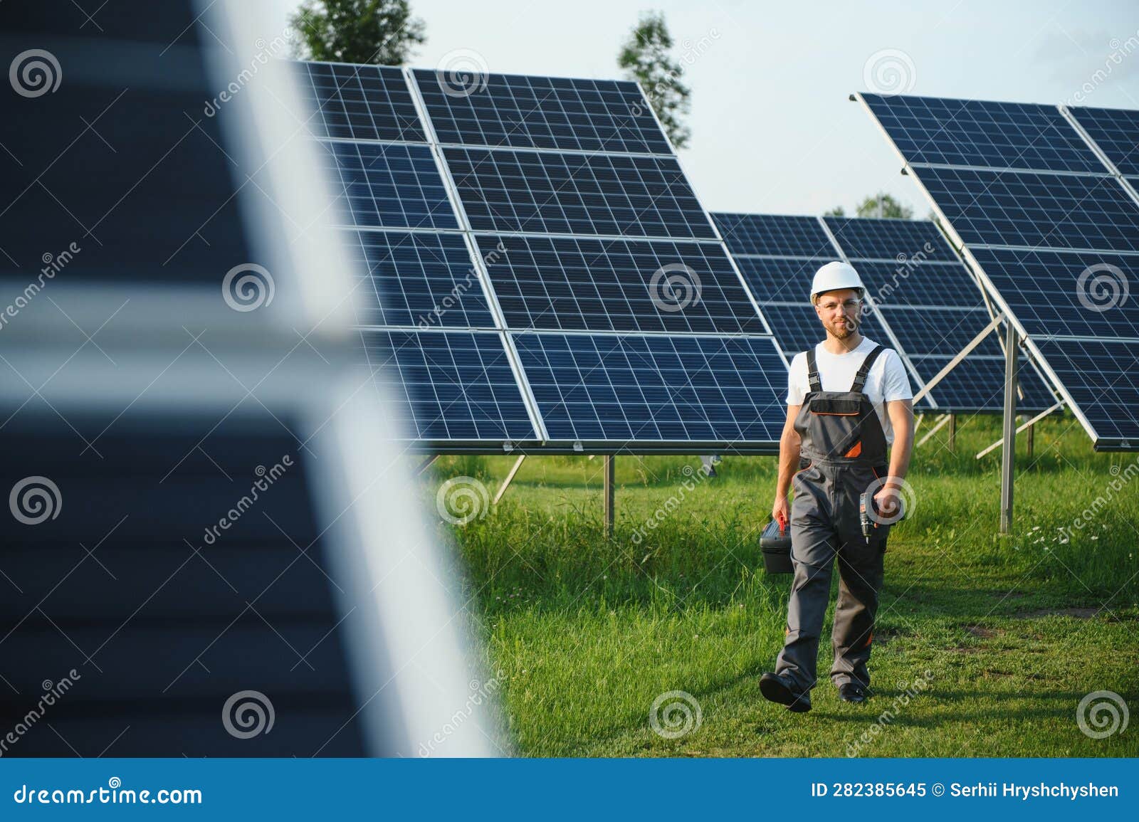 Side View of Male Worker Installing Solar Modules and Support ...