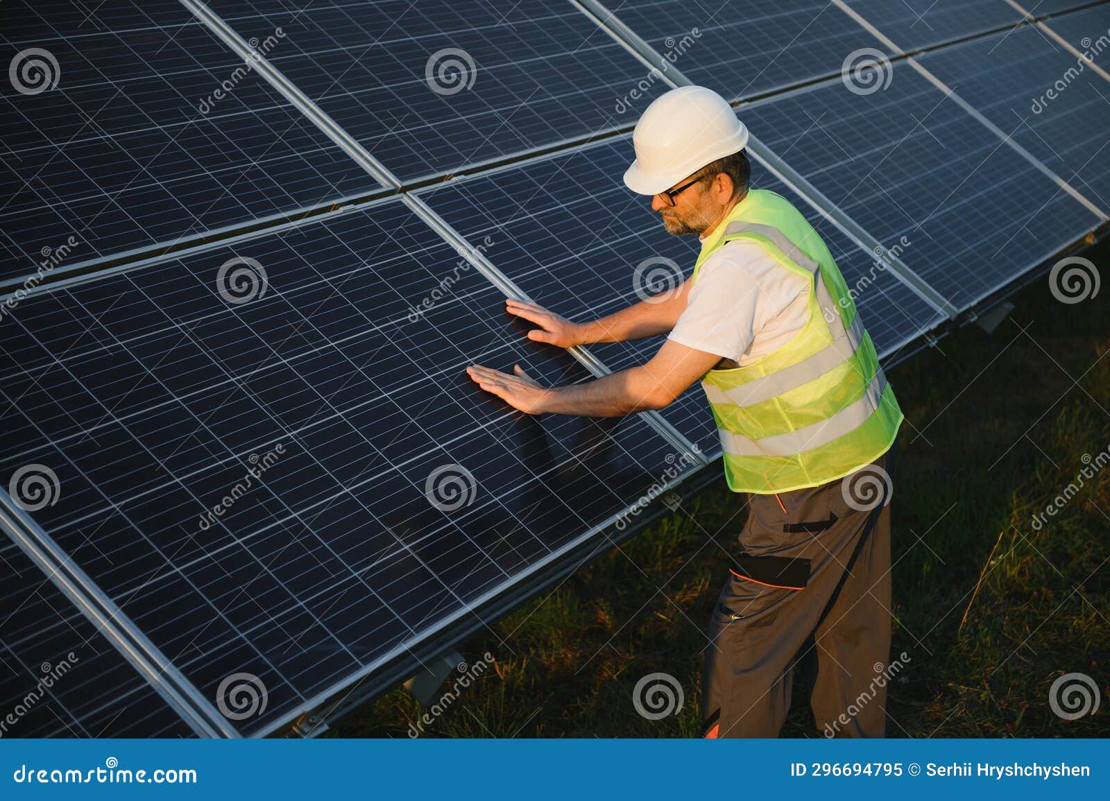 Side View of Male Worker Installing Solar Modules and Support ...