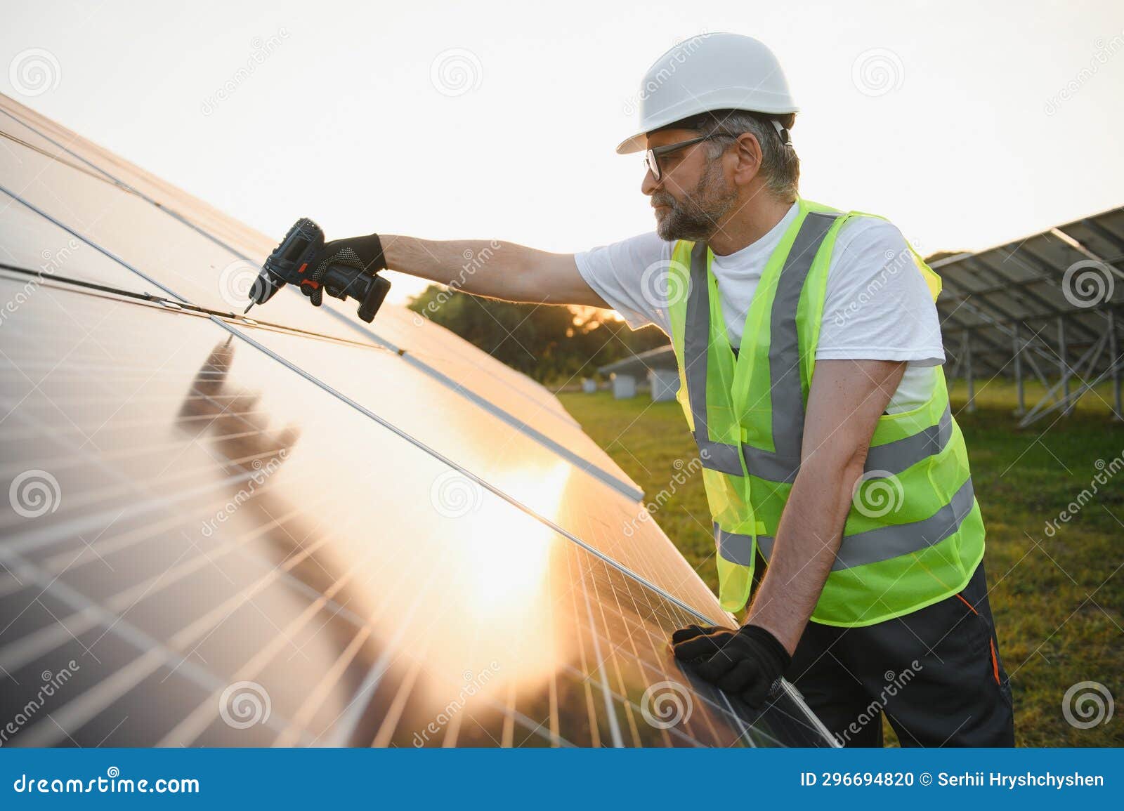 Side View of Male Worker Installing Solar Modules and Support ...