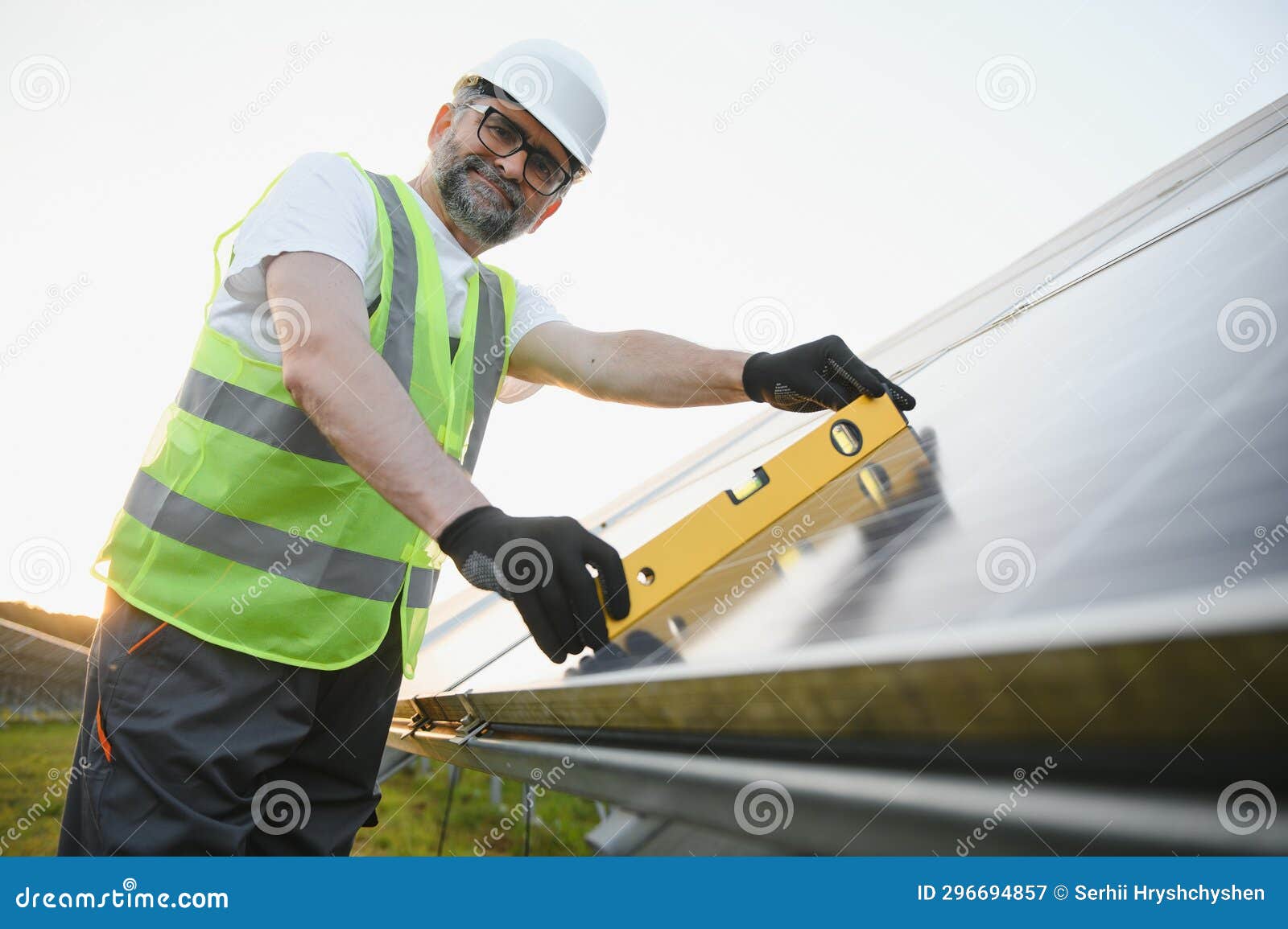 Side View of Male Worker Installing Solar Modules and Support ...