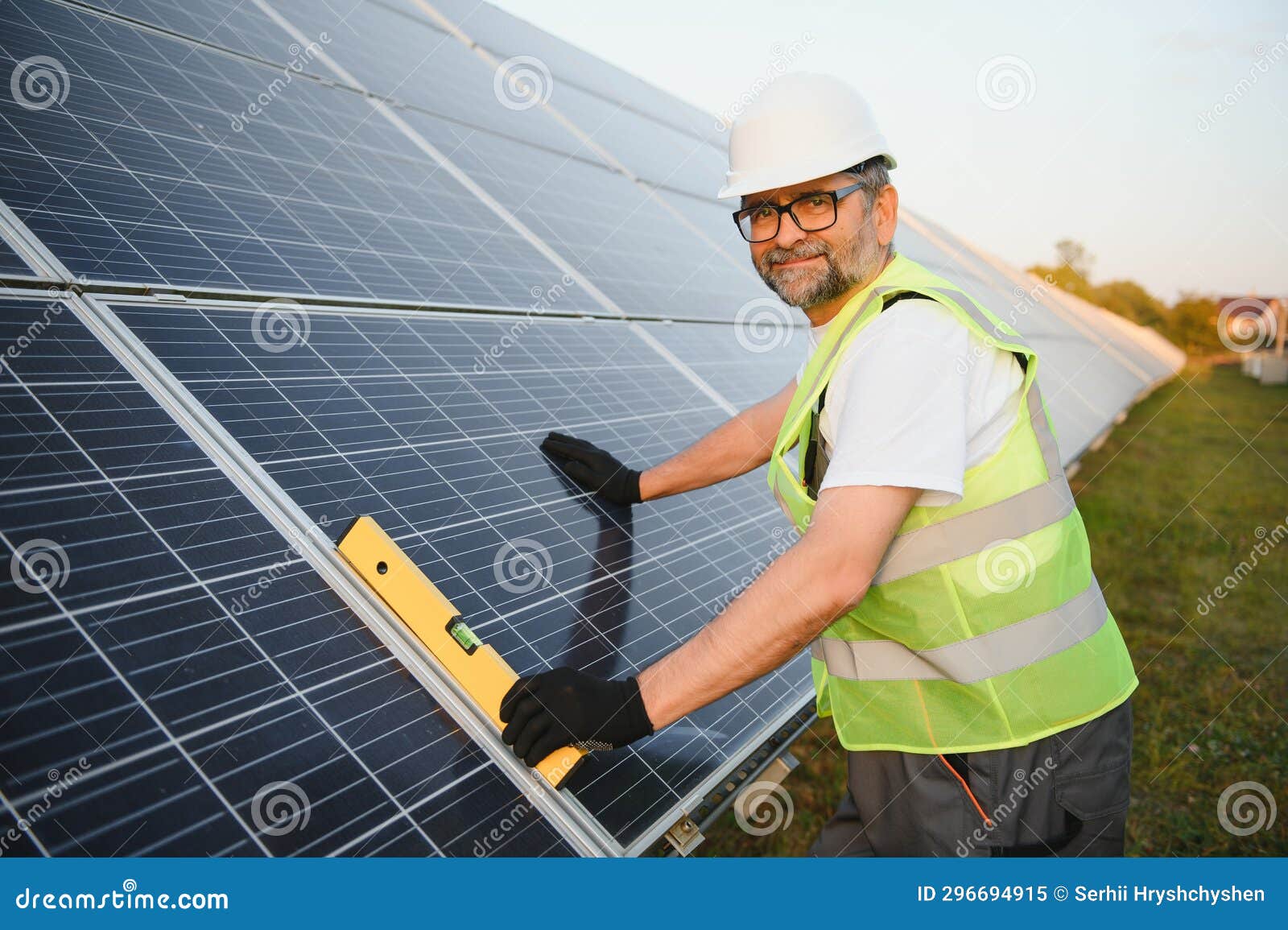 Side View of Male Worker Installing Solar Modules and Support ...