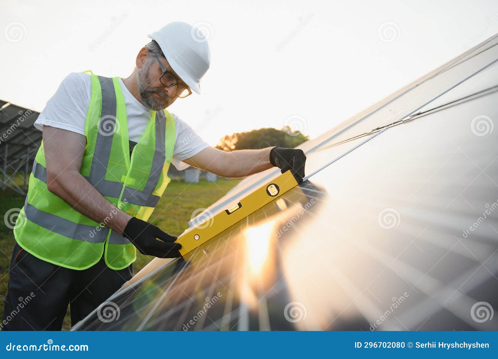 Side View of Male Worker Installing Solar Modules and Support ...
