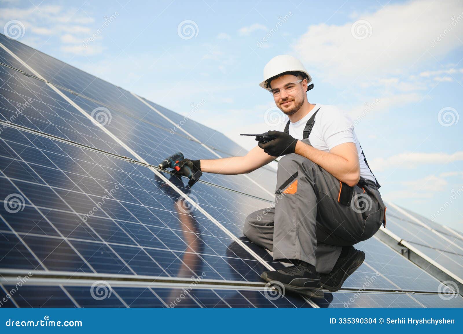 Side View of Male Worker Installing Solar Modules and Support ...