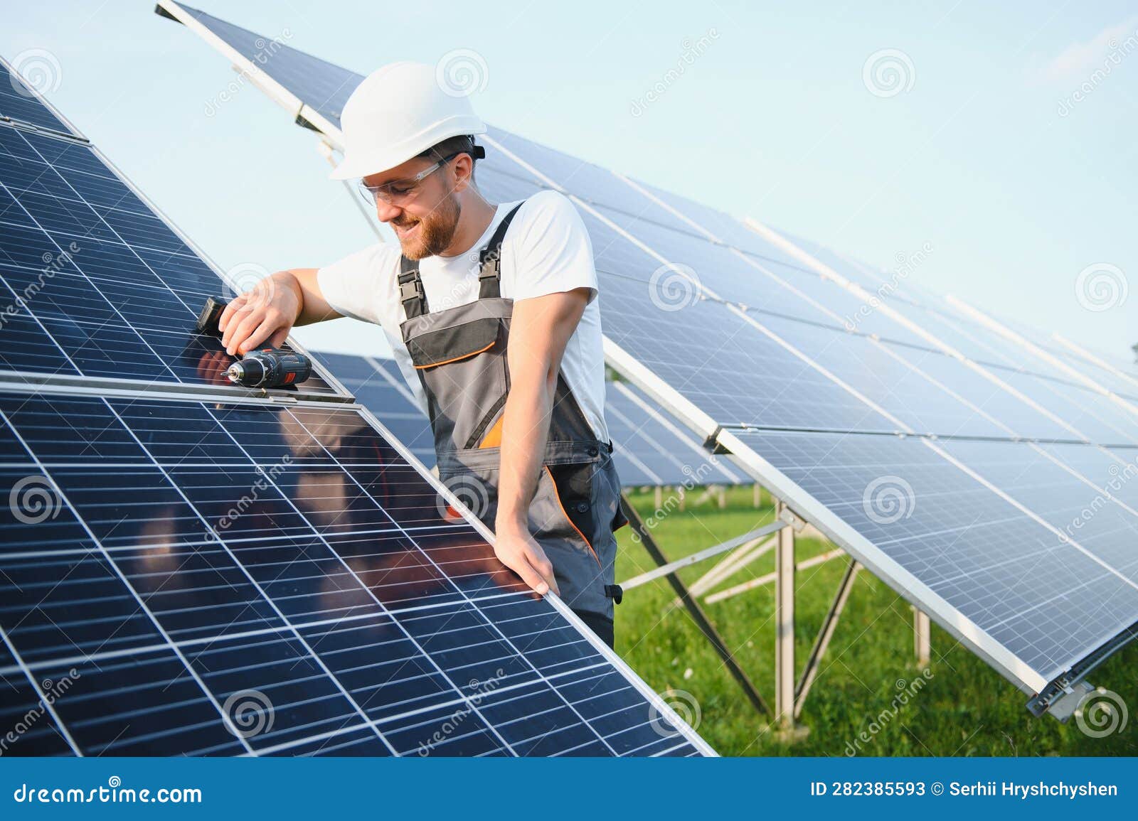 Side View of Male Worker Installing Solar Modules and Support ...