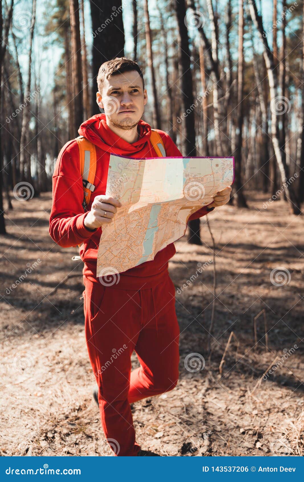 Traveling Man with Map in Woods. Side View of Man with Backpack Reading ...