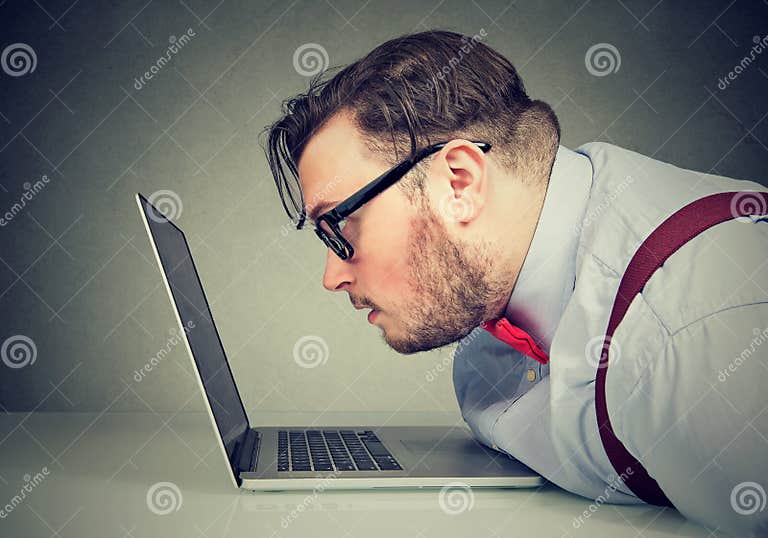 Side View of a Man with Bad Vision Having Difficulty To Read Email ...