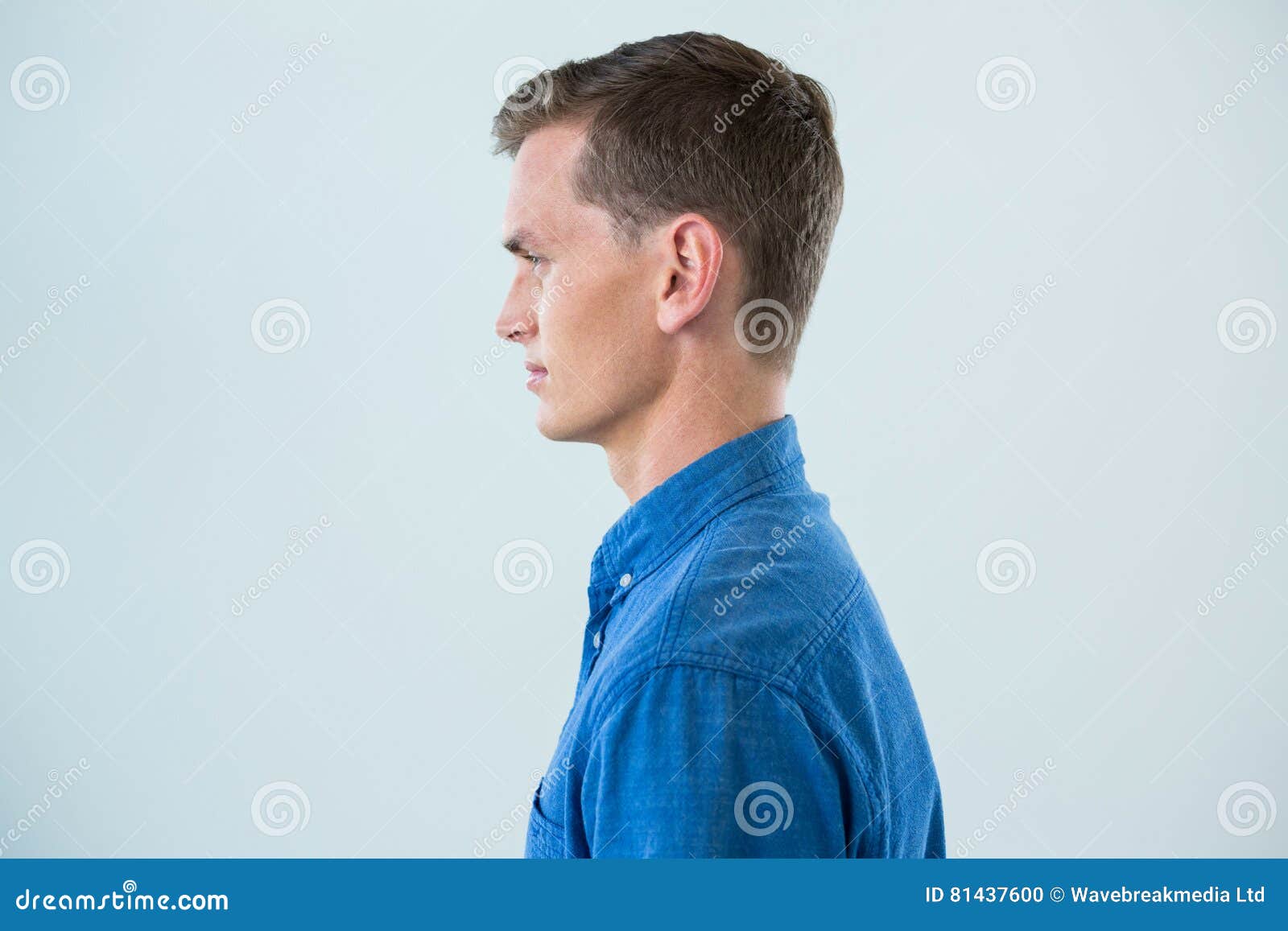 Side View of Man in Blue Shirt Stock Photo - Image of studio, male ...