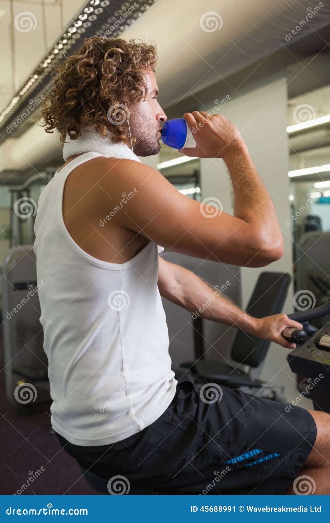 Side View of Man Drinking Water on Exercise Bike at Gym Stock Image ...