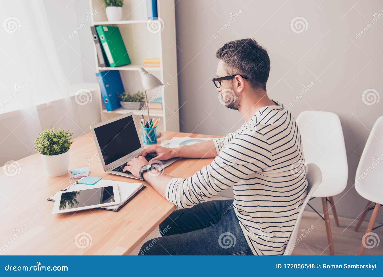 Side View of Man in Glasses Writing Book on Laptop Stock Photo - Image ...