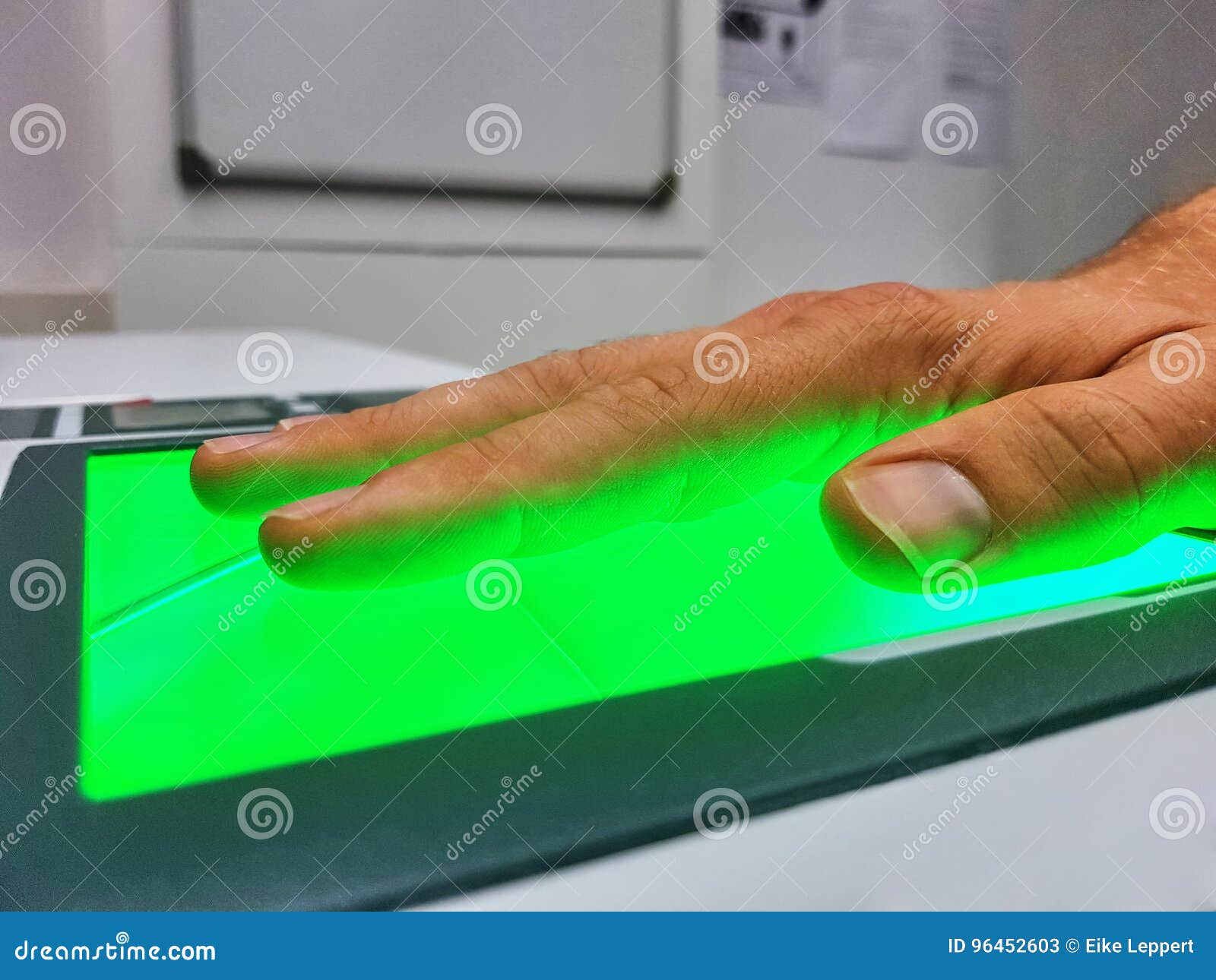 Side View from a Man Using a Fingerprint Scanner for Identification ...